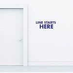 Reusable Line Starts Here Wall Sign Graphic | Sticker Genius